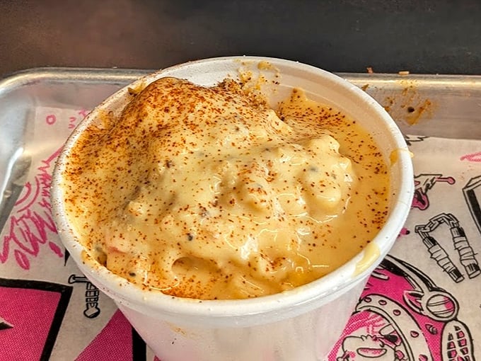 Mac and cheese that doesn't just sit there looking pretty – it bubbles with molten goodness under a dusting of spices like a dairy volcano about to erupt.