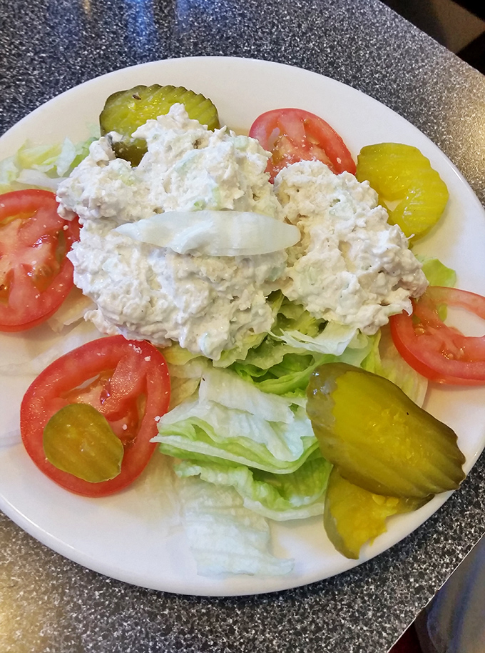 Even the salads mean business at Kuppy's, where chicken salad crowns fresh lettuce, tomatoes, and pickles in a simple but satisfying lunch option.