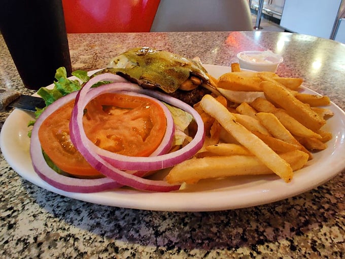 This isn't just a burger – it's a perfectly constructed tower of fresh ingredients that demands both hands and several napkins.