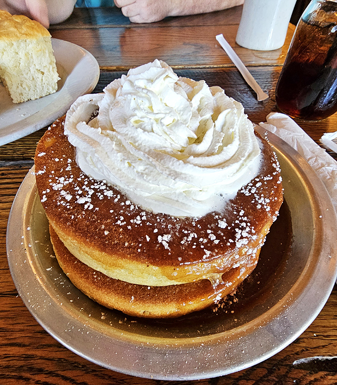 Pancakes stacked higher than a Tennessee tale! This golden tower of fluffy goodness comes crowned with a cloud of whipped cream.