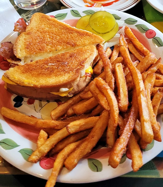 Three cheeses conspiring together between toasted bread to create melted magic on a plate.