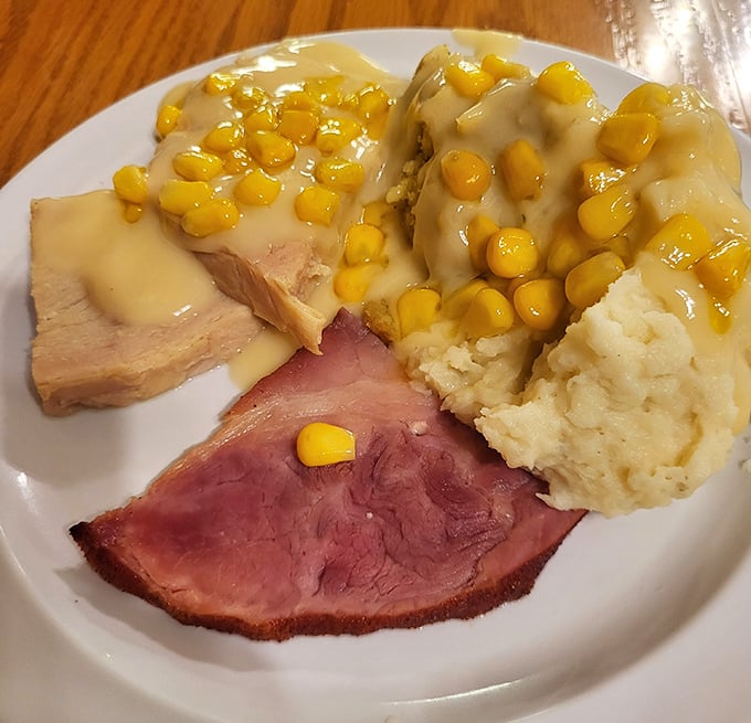 Ham loaf with mashed potatoes and corn—a plate that screams "Midwest comfort" louder than a high school basketball coach during championship season.