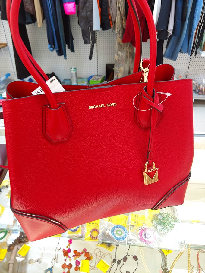 That red Michael Kors bag isn't just arm candy—it's proof that luxury and thrift can coexist beautifully in the same shopping cart.