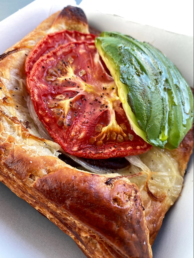 Not just a pastry but a statement piece—flaky dough cradles roasted tomato and avocado in what might be the most photogenic breakfast in LA.
