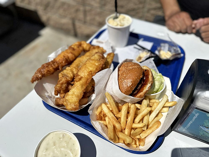 The holy trinity of fish, burger, and fries—a coastal California communion that satisfies both land and sea cravings in one glorious tray.