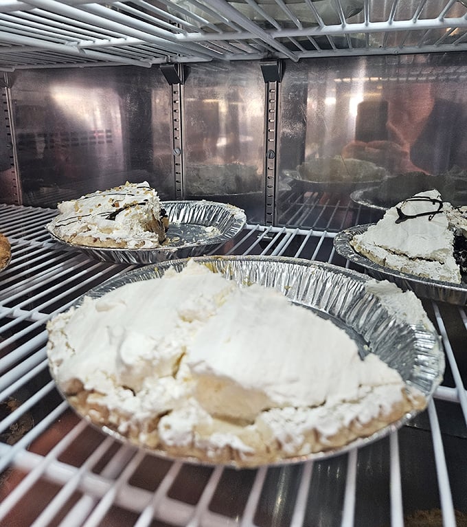 Pie heaven awaits in that display case. Each tin holds the kind of dessert that makes you seriously consider ordering it before your main course.