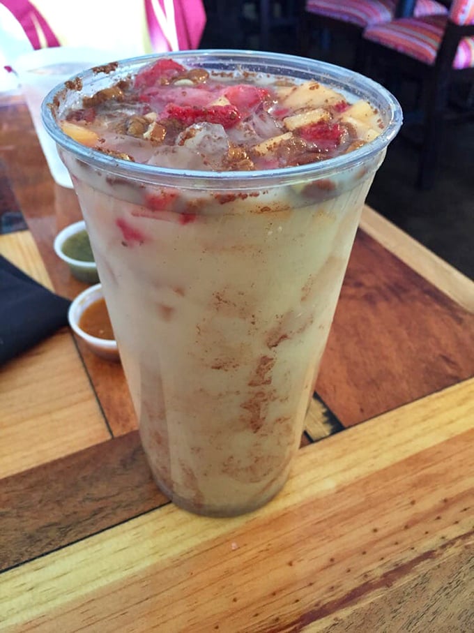 This isn't just horchata—it's a cinnamon-kissed cloud in a cup, topped with fresh fruit that transforms a simple drink into dessert's cool cousin.