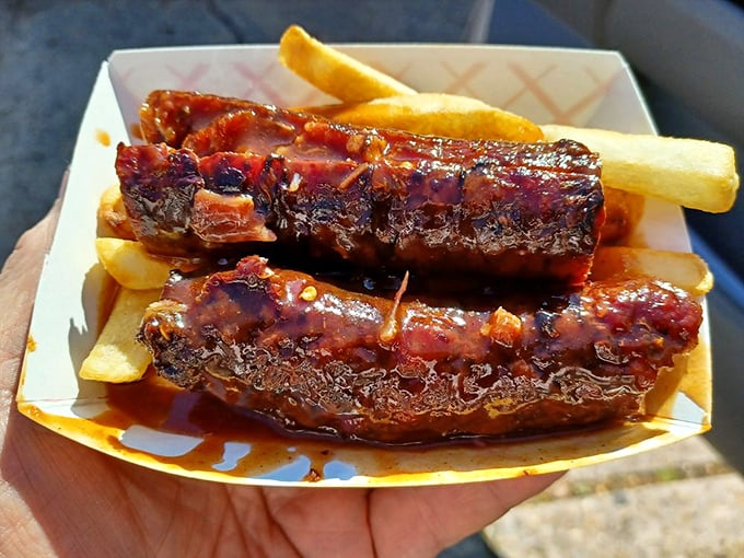 Hot links and sauce on rustic paper—proof that sometimes the most transcendent culinary experiences come without china plates or cloth napkins.
