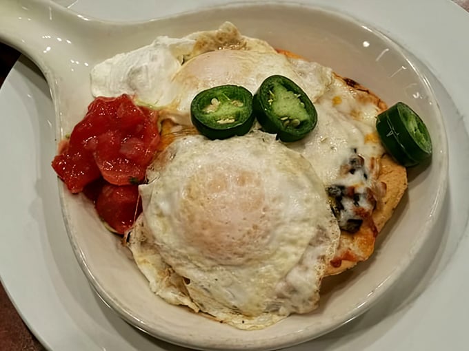 Southwestern breakfast magic: a sunny-side-up egg crowns this fiesta of flavors, with jalapeños standing guard like spicy sentinels.