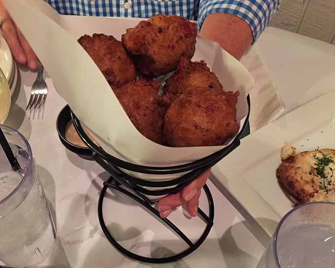 These hush puppies arrive hot and crispy, like little cornmeal clouds that somehow learned to fry themselves.