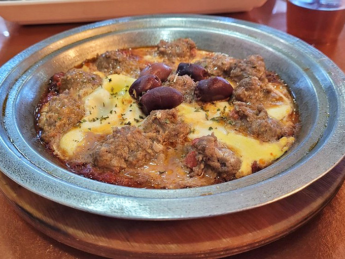 The Kefta Tagine arrives bubbling with promise—seasoned meatballs swimming in a rich tomato sauce with eggs that have poached to creamy perfection.
