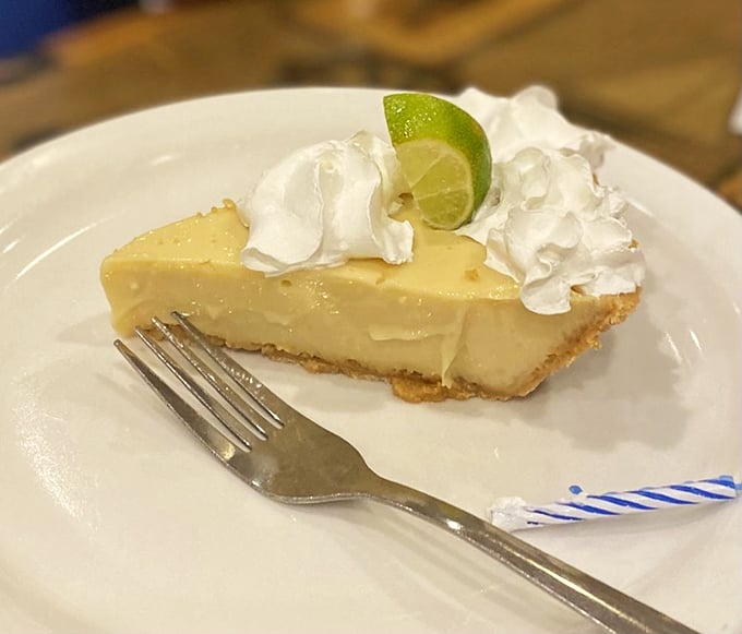 The key lime pie that launched a thousand road trips. That pale yellow hue? That's authenticity calling—no food coloring needed when real key limes are involved.