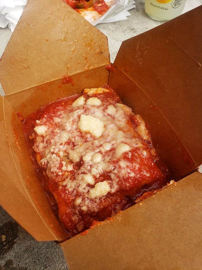 This lasagna isn't messing around. Layers of pasta, cheese, and sauce combine in a cardboard container that barely contains its magnificence.