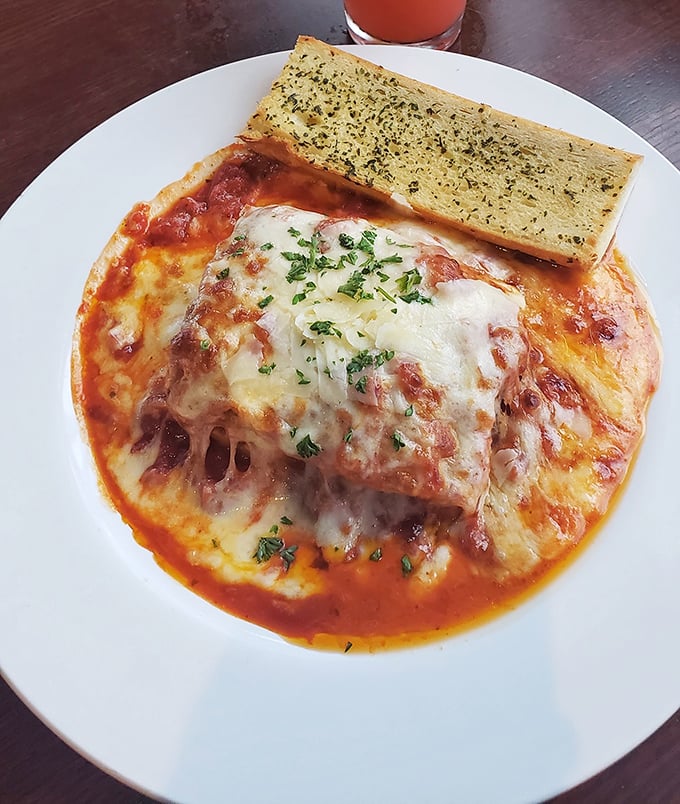 Lasagna that doesn't know when to quit, with layers upon layers of pasta, cheese, and sauce. That garlic bread isn't just a side – it's essential equipment.