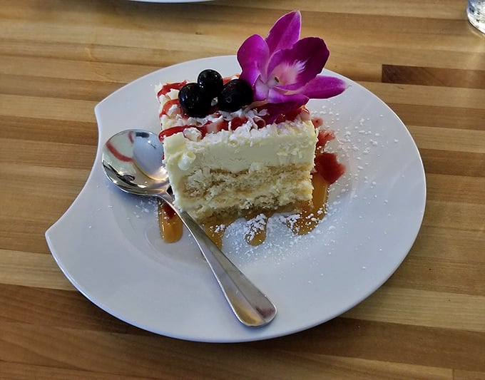 This lemon cake adorned with fresh berries and an orchid isn't just dessert—it's edible artwork that's almost too pretty to eat. Almost.