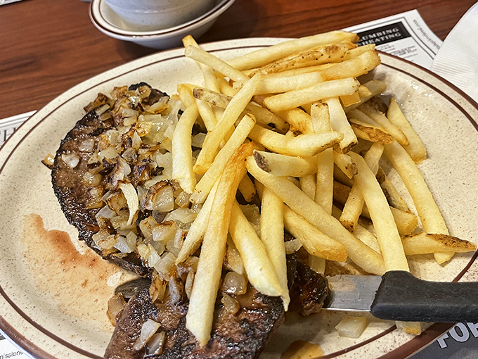Liver and onions with a mountain of fries—a dish that separates casual diners from true comfort food aficionados. Your grandfather would approve.