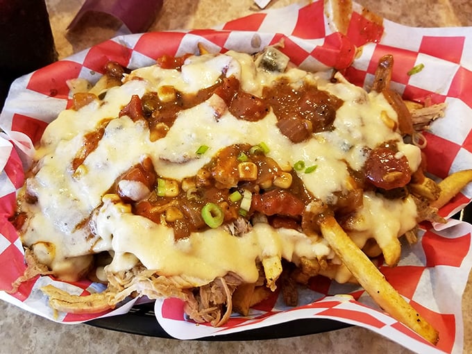 Loaded fries that blur the line between side dish and main event. A mountain of pulled pork, cheese, and green onions that demands to be shared—or not.