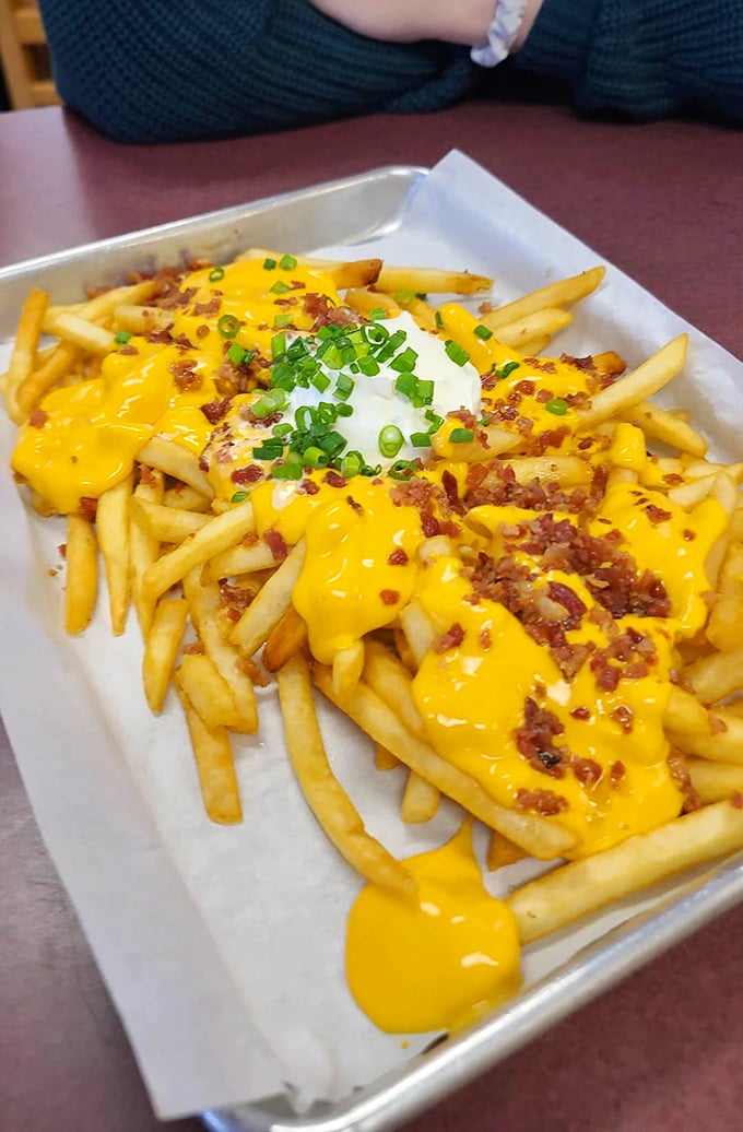 The "Whatever Fries" in their full glory—a mountain of potatoes buried under cheese, bacon bits, and green onions. Diet plans come here to die gloriously.