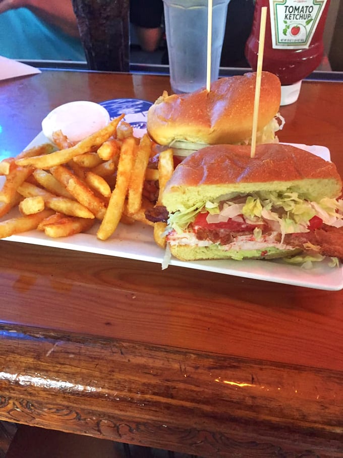 These lobster club sandwiches weren’t just a meal—they were handheld happiness, served in hearty halves alongside crispy fries that made you forget all about your diet plans.