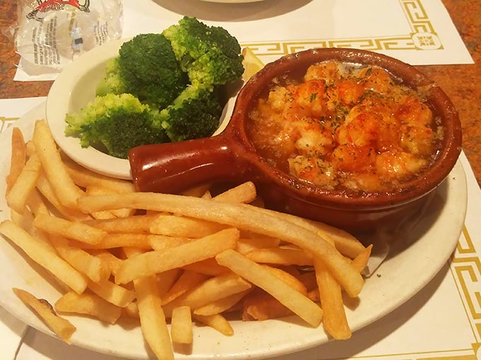 The lobster pot arrives like a ceramic treasure chest, golden and bubbling, making neighboring tables experience a serious case of order envy.