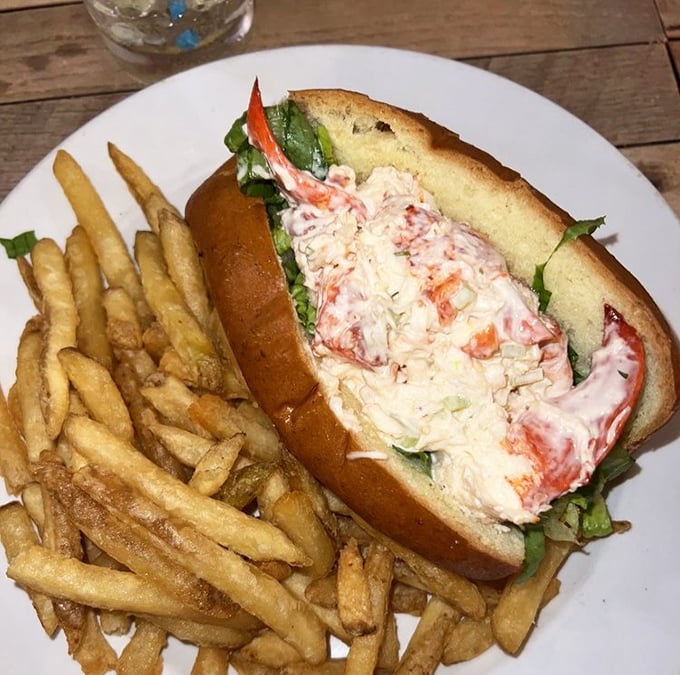 A lobster roll that doesn't need New England's permission – chunks of sweet lobster meat nestled in a buttery roll alongside crispy fries.
