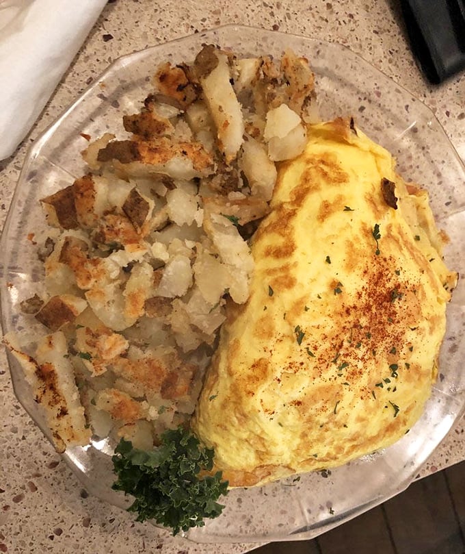 This omelet isn't just fluffy—it's what clouds wish they could be when they grow up, paired with home fries crisped to perfection.