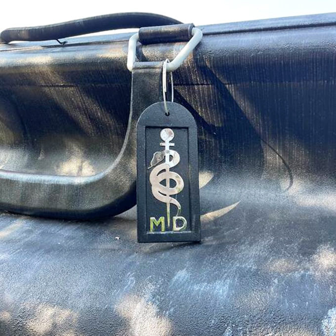 The MD tag features the caduceus symbol – medicine's ancient logo that says, "Trust me, I went to school for this."