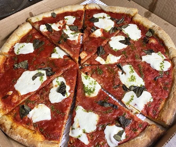Classic margherita pizza showcasing fresh mozzarella dollops like edible clouds floating on a vibrant tomato sunset.
