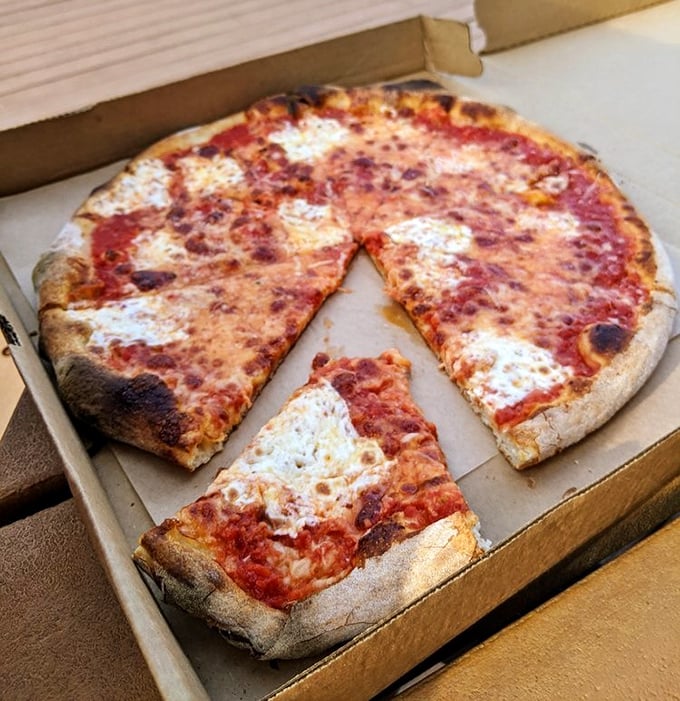The Margherita pizza in its takeout box—proof that even when traveling, Beddia's magic remains intact, ready to transform your kitchen table.