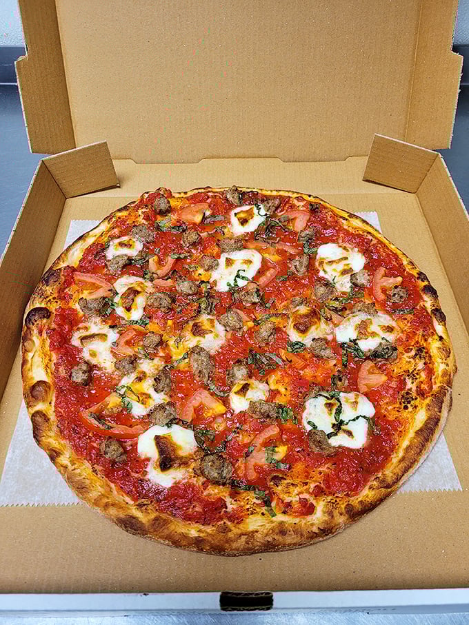 Sausage and fresh mozzarella on a perfect crust – proof that sometimes the simplest combinations create the most profound happiness.