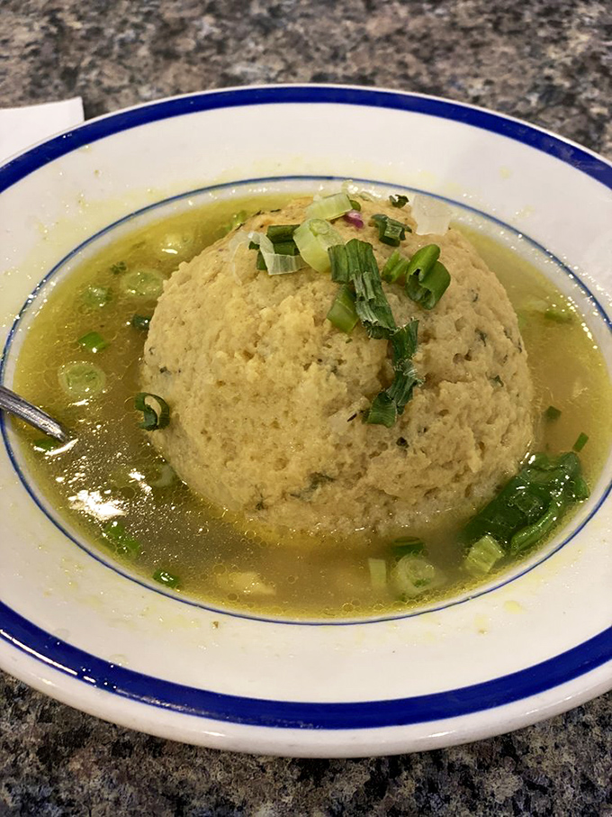 This matzo ball soup doesn't float – it commands the bowl with the confidence of something that knows exactly how delicious it is.