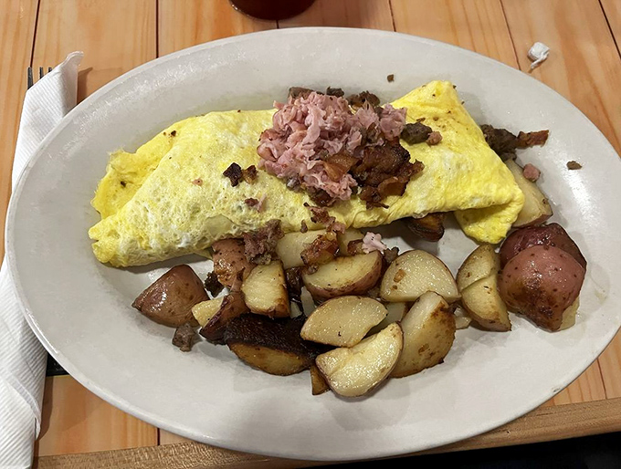 An omelet that doesn't just contain meat – it celebrates it. Paired with perfectly seasoned potatoes, it's breakfast nirvana for dedicated carnivores.