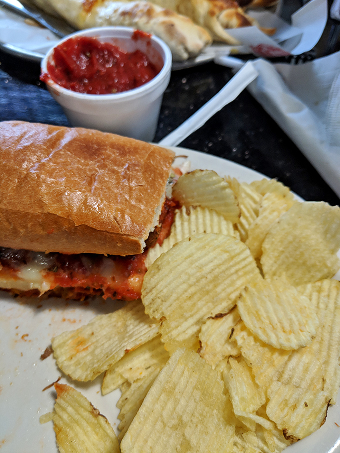 Sandwich architecture at its finest. This sub with chips isn't just lunch—it's structural integrity meeting flavor engineering in perfect harmony.