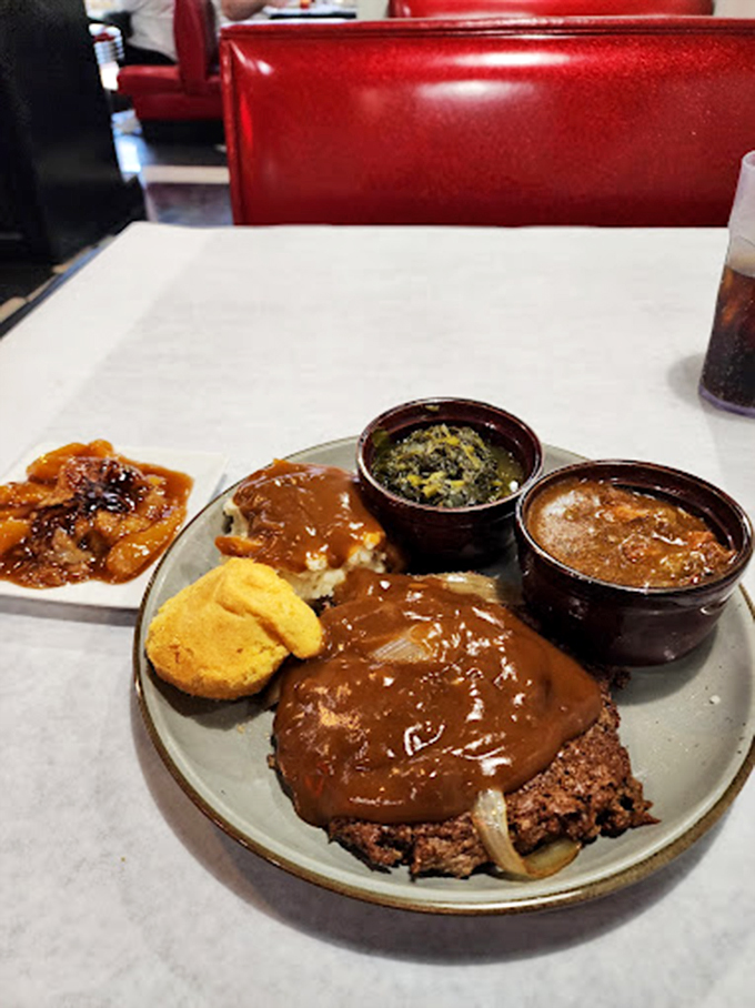 Meatloaf smothered in rich gravy with cornbread and sides—proof that grandma's recipes never go out of style, they just find new kitchens to shine in.