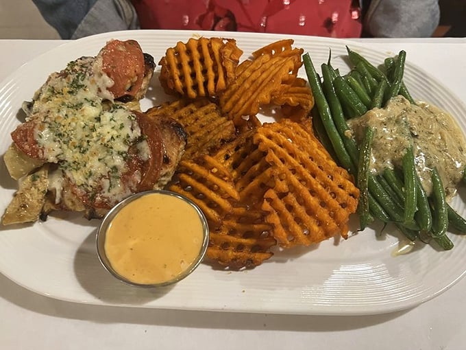 Sweet potato waffle fries and perfectly cooked protein—a plate that proves vegetables can party too. The sauce adds that "where have you been all my life?" element.