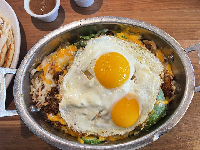 This sizzling skillet is what happens when breakfast decides to dress for success – those sunny-side-up eggs are practically winking at you.