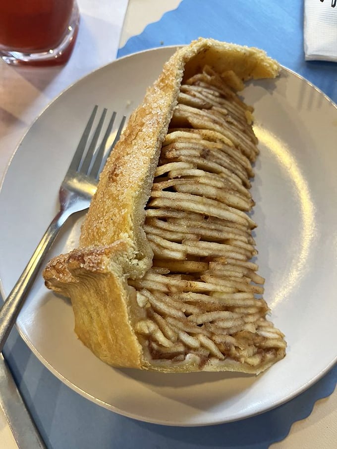 The legendary Levee High Apple Pie in all its architectural glory—a skyscraper of thinly-sliced apples that makes Manhattan's skyline look unambitious.
