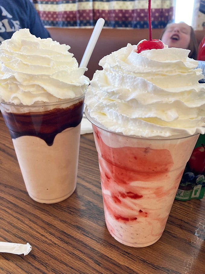 Milkshakes so thick they laugh at your straw. One chocolate, one strawberry, both demanding a moment of respectful silence.