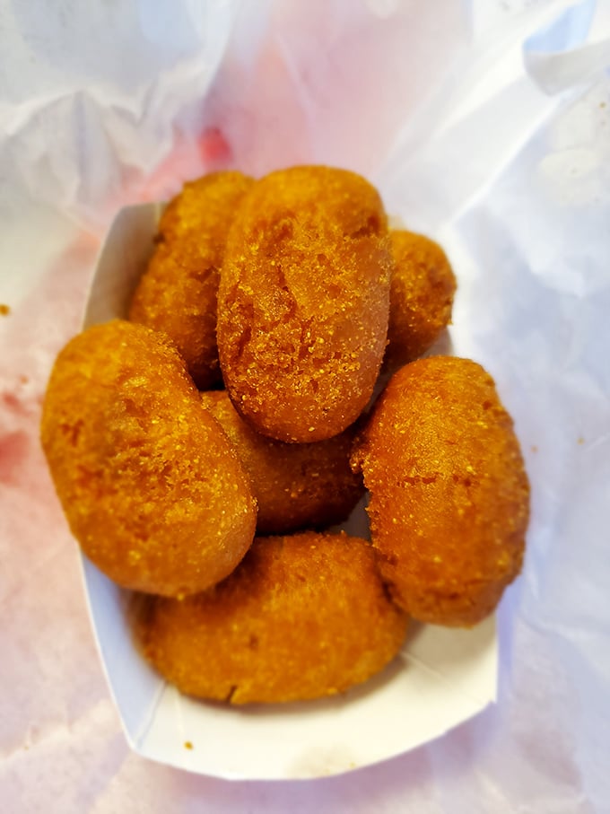 Golden-fried hush puppies that crunch like childhood memories – crispy outside, tender inside, and worth every single calorie.