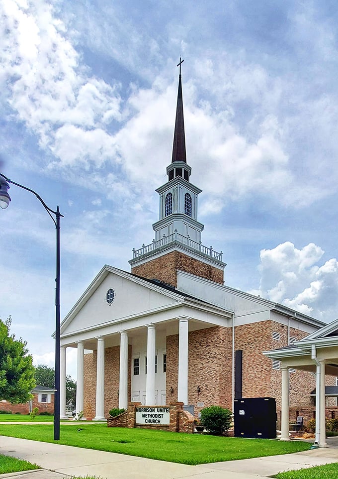Morrison United Methodist Church's soaring steeple reaches skyward like a spiritual exclamation point, its brick and white façade a landmark of community faith.