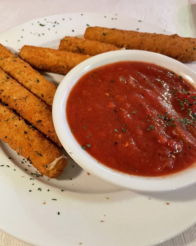 These aren't just mozzarella sticks—they're crispy golden vessels delivering molten cheese to your soul, with marinara as their trusty sidekick.