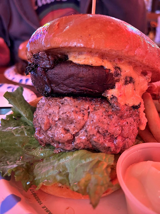 The mushroom burger doesn't just sit on the plate—it looms, a magnificent tower of umami that makes you wonder if you should take a photo or just unhinge your jaw.