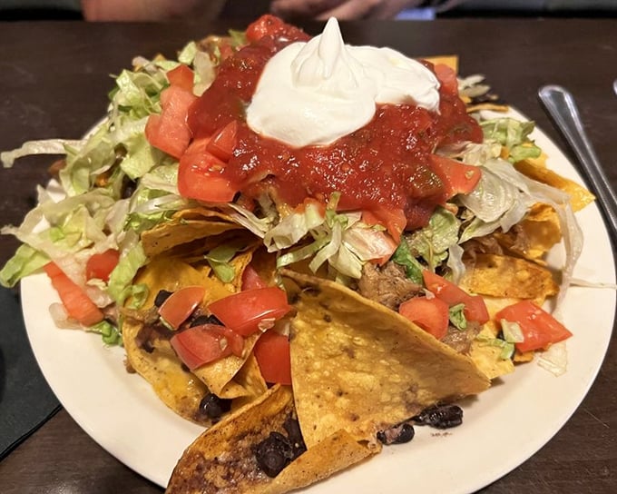 Nachos piled high enough to require structural engineering consultation – bring your appetite and maybe some backup.
