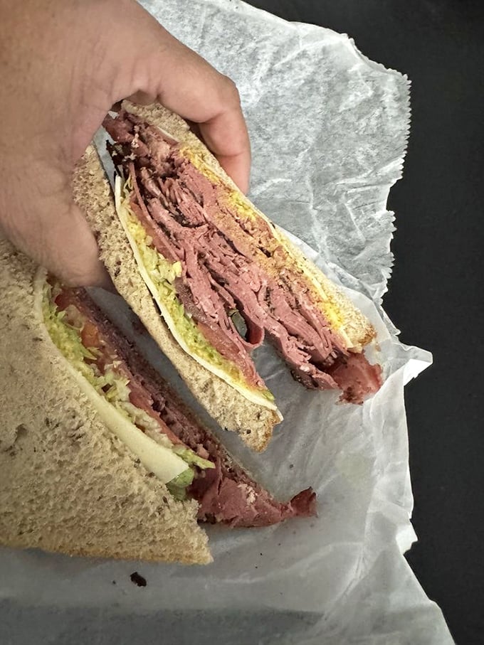 The New Yorker doesn't need to shout to get attention. Pastrami and Swiss on rye—a sandwich that knows exactly what it is.