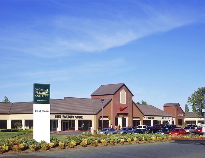 The Vacaville Premium Outlets sign stands proudly beside Nike Factory Store, a beacon for bargain hunters with champagne taste and beer budgets.