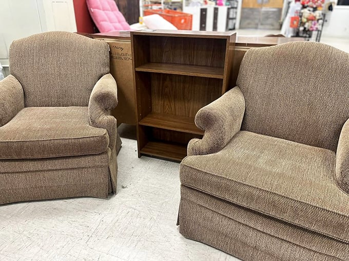 Cozy club chairs flanking a bookshelf—the perfect setup for those "I'm just going to read for five minutes" sessions that become hours.