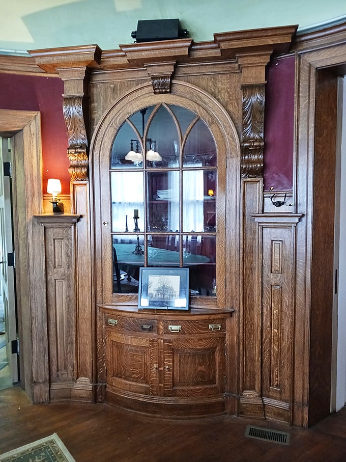 This built-in cabinet isn't just furniture—it's functional art, with arched glass that transforms ordinary dishes into museum-worthy displays.