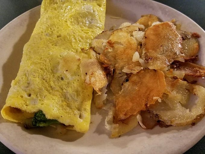 An omelet that doesn't need to show off, paired with home fries that clearly graduated with honors from Breakfast Academy.