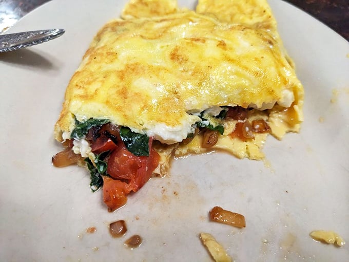 This isn't just any omelet – it's a fluffy envelope of eggs delivering a love letter of vegetables and cheese to your taste buds.