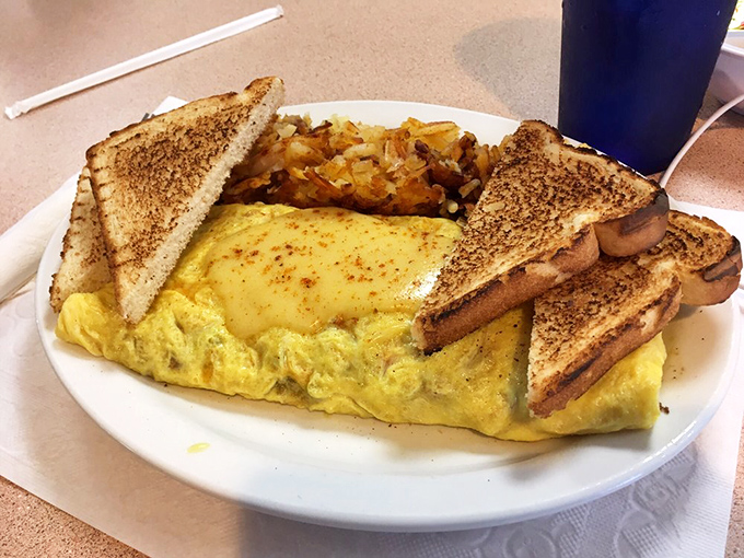 This isn't just an omelet—it's a perfectly folded envelope delivering a message of breakfast joy, with crispy toast as the exclamation point.